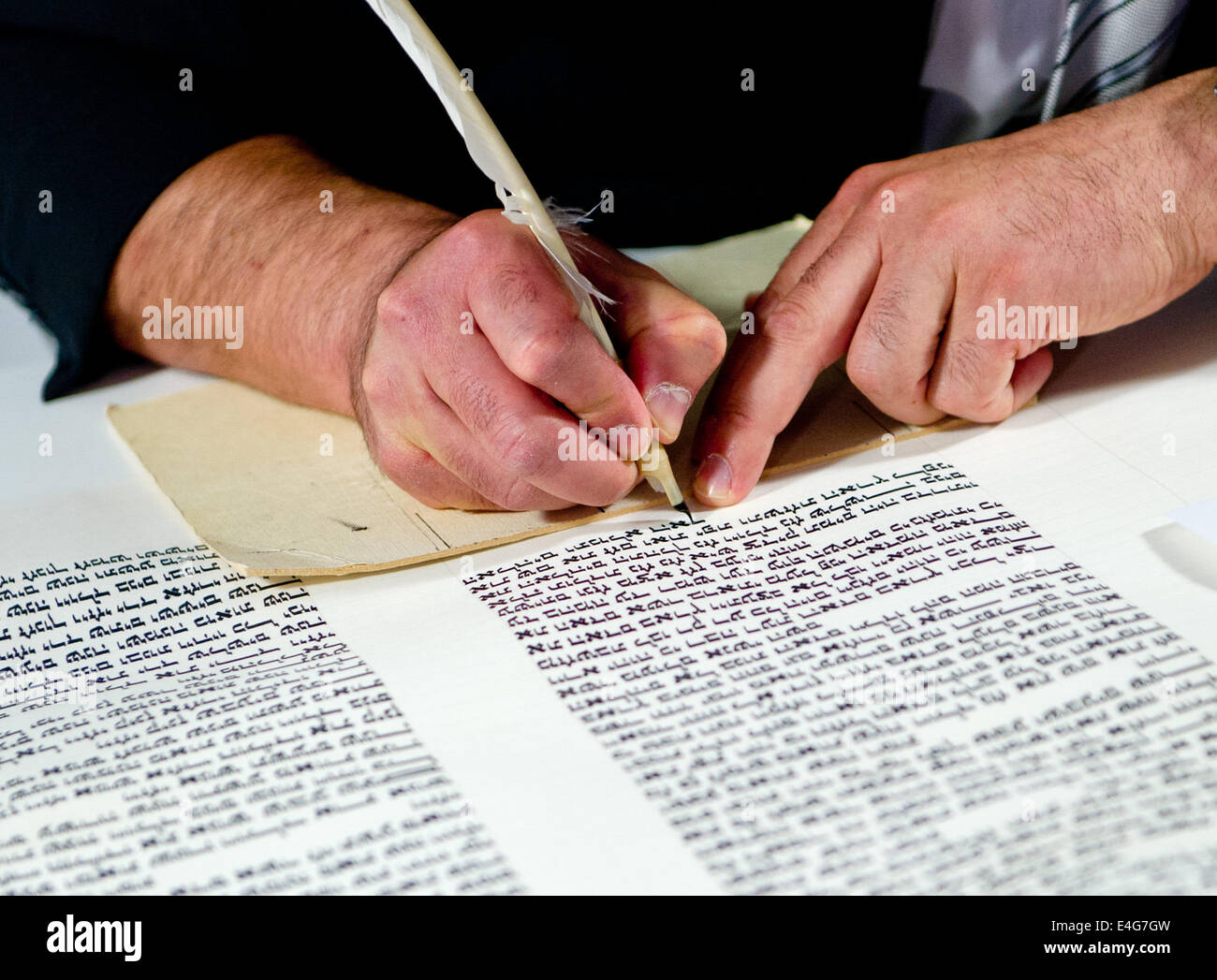 Torah writer rabbi Reuven Yaacobov works on a Torah at the Jewish ...