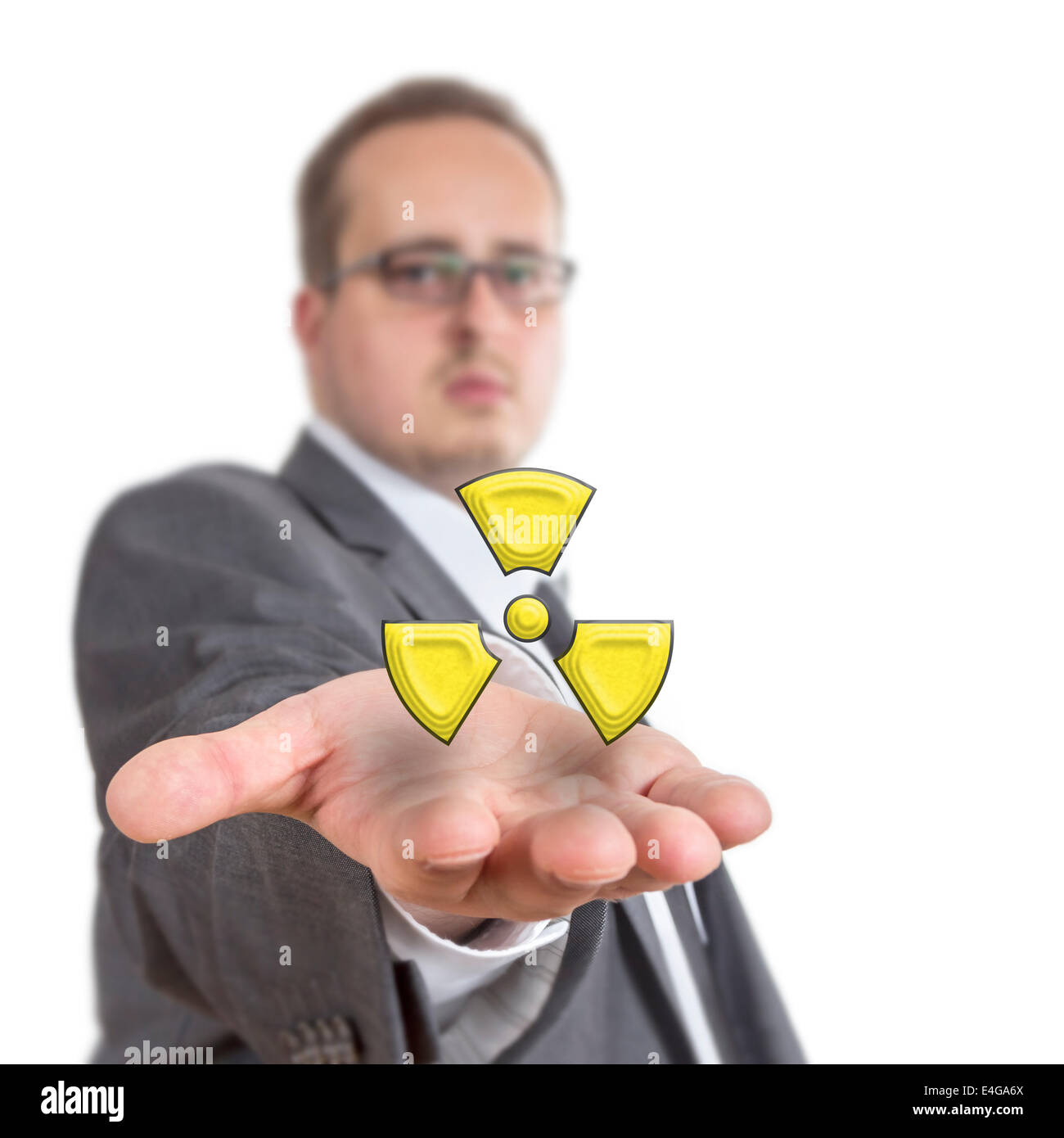 Business man reaches out his arm with a radioactive symbol floating ...