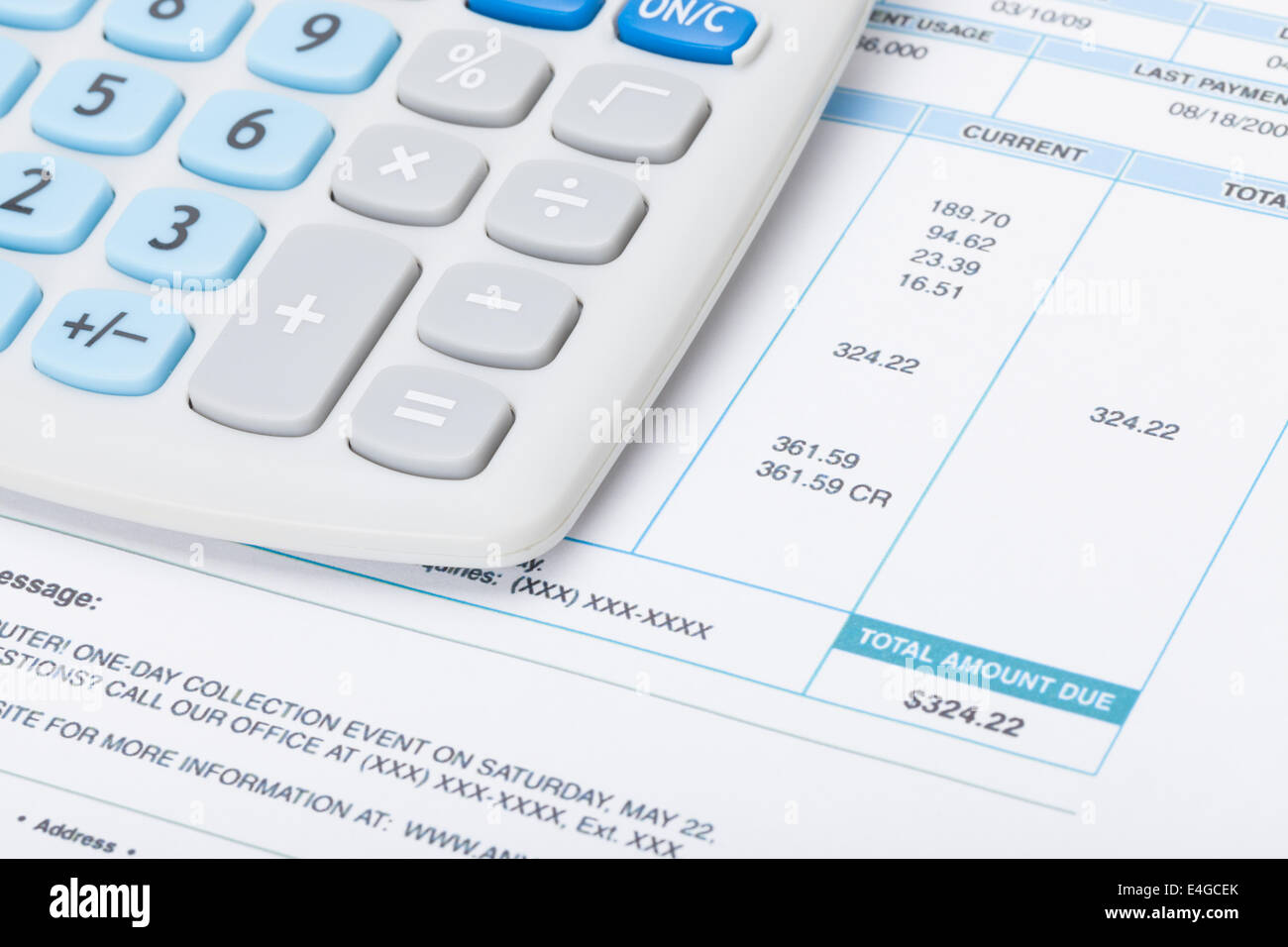Receipt next to calculator - studio shot Stock Photo - Alamy