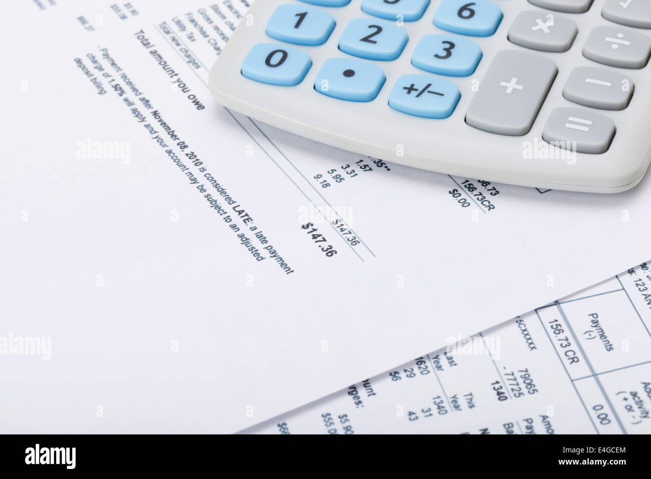 Receipt next to calculator Stock Photo - Alamy