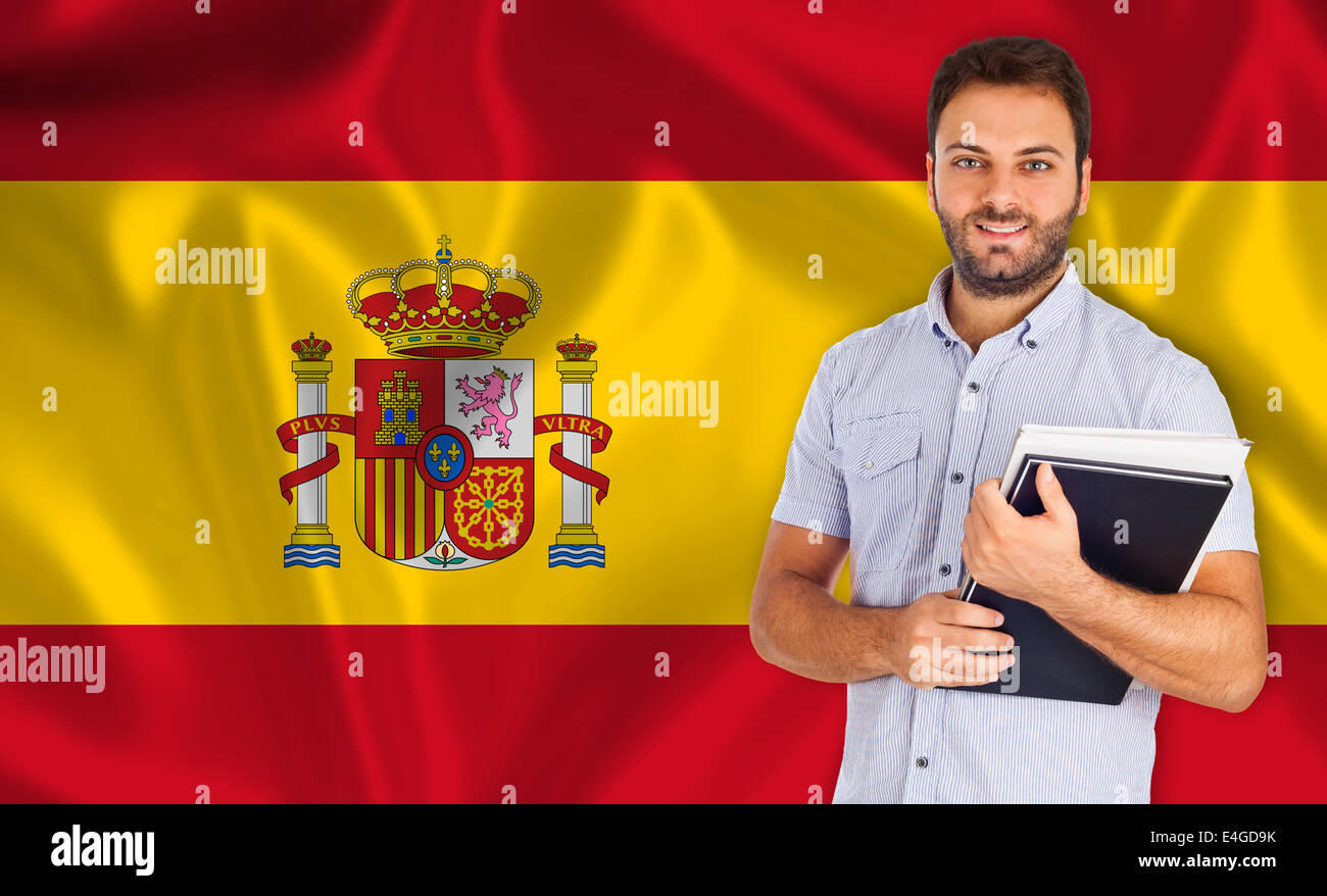Young male student smiling over Spanish flag Stock Photo - Alamy