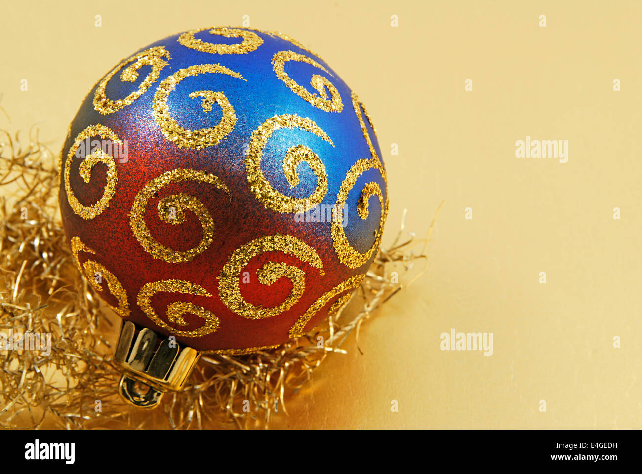 Beautiful colorful Christmas ball with a chain on a golden background ...