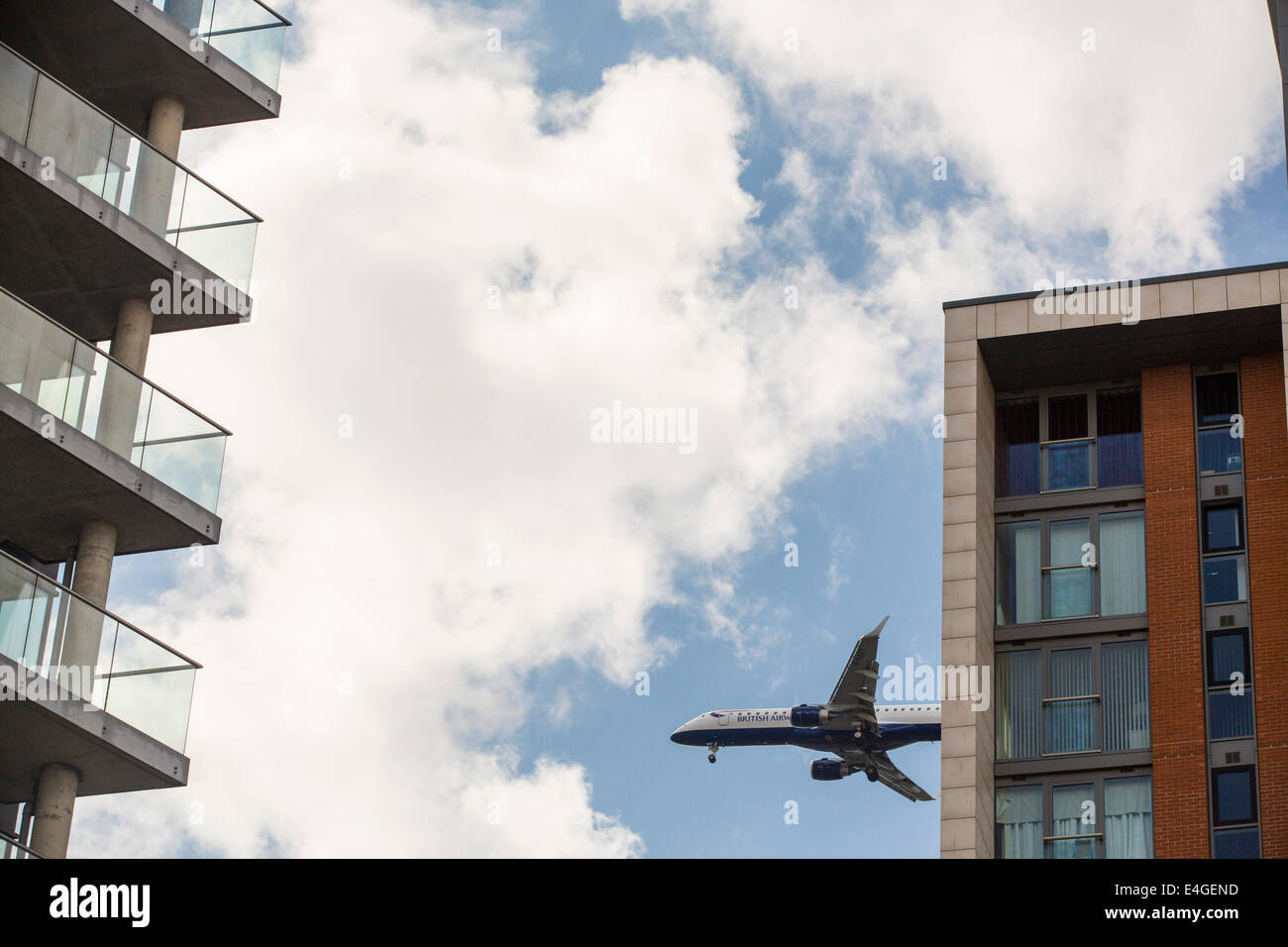A plane flying past apartment blocks as it comes into land at City ...