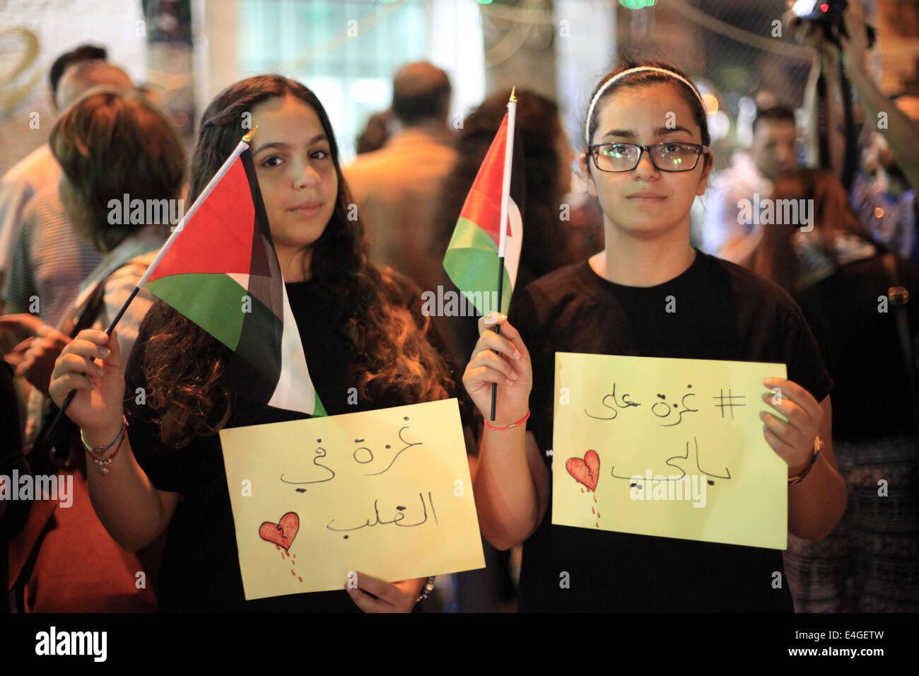 Ramallah, West Bank, Palestine. 11th July, 2014. Girls hold signs "Gaza ...