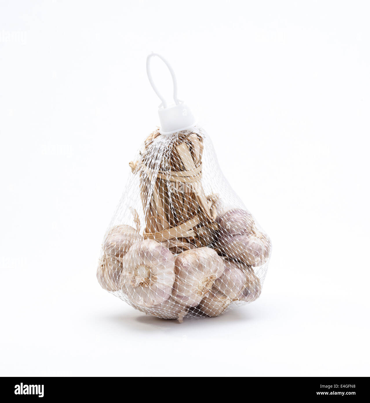 Organic garlics in net pouch isolated on white background Stock Photo ...
