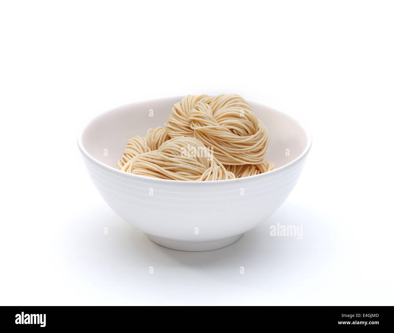 Chinese dried noodles style in a white bowl isolated on white ...