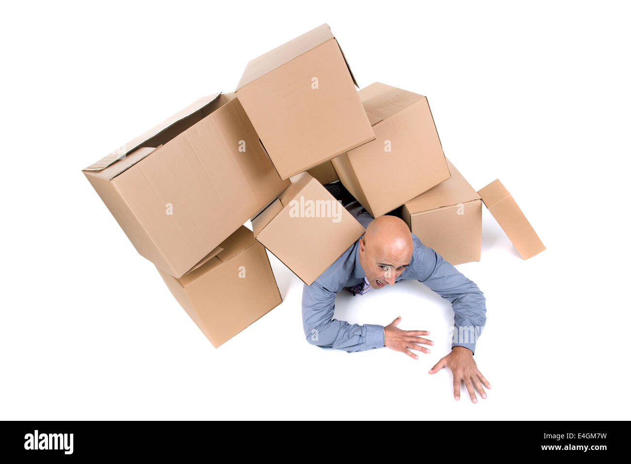 Stressed businessman under a pile of cardboard boxes Stock Photo - Alamy
