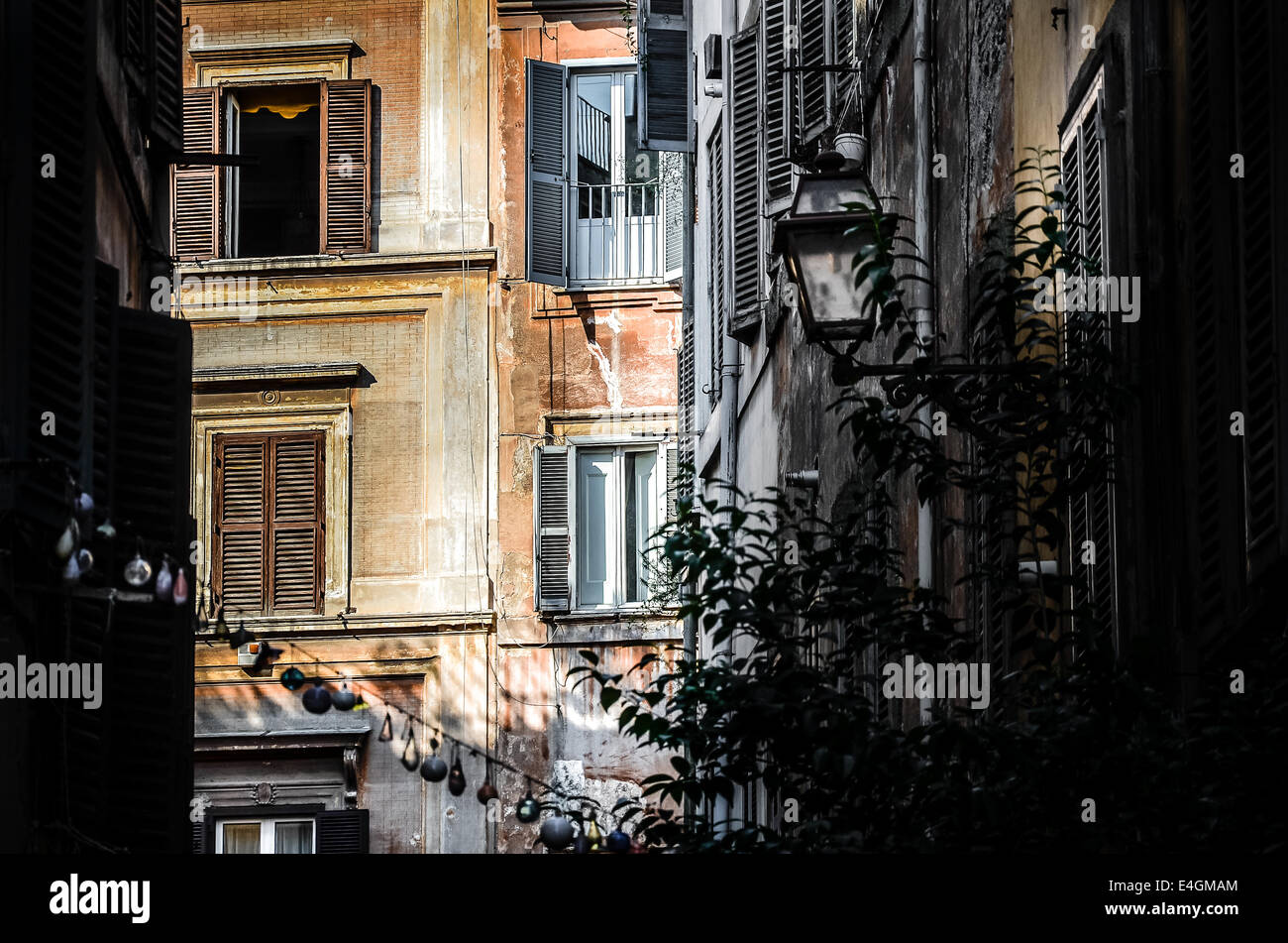 Narrow street in Rome with bright sunny building Stock Photo - Alamy