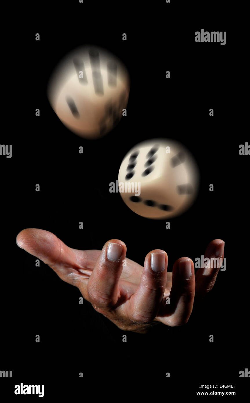 Hand throwing dice in a dark background Stock Photo - Alamy