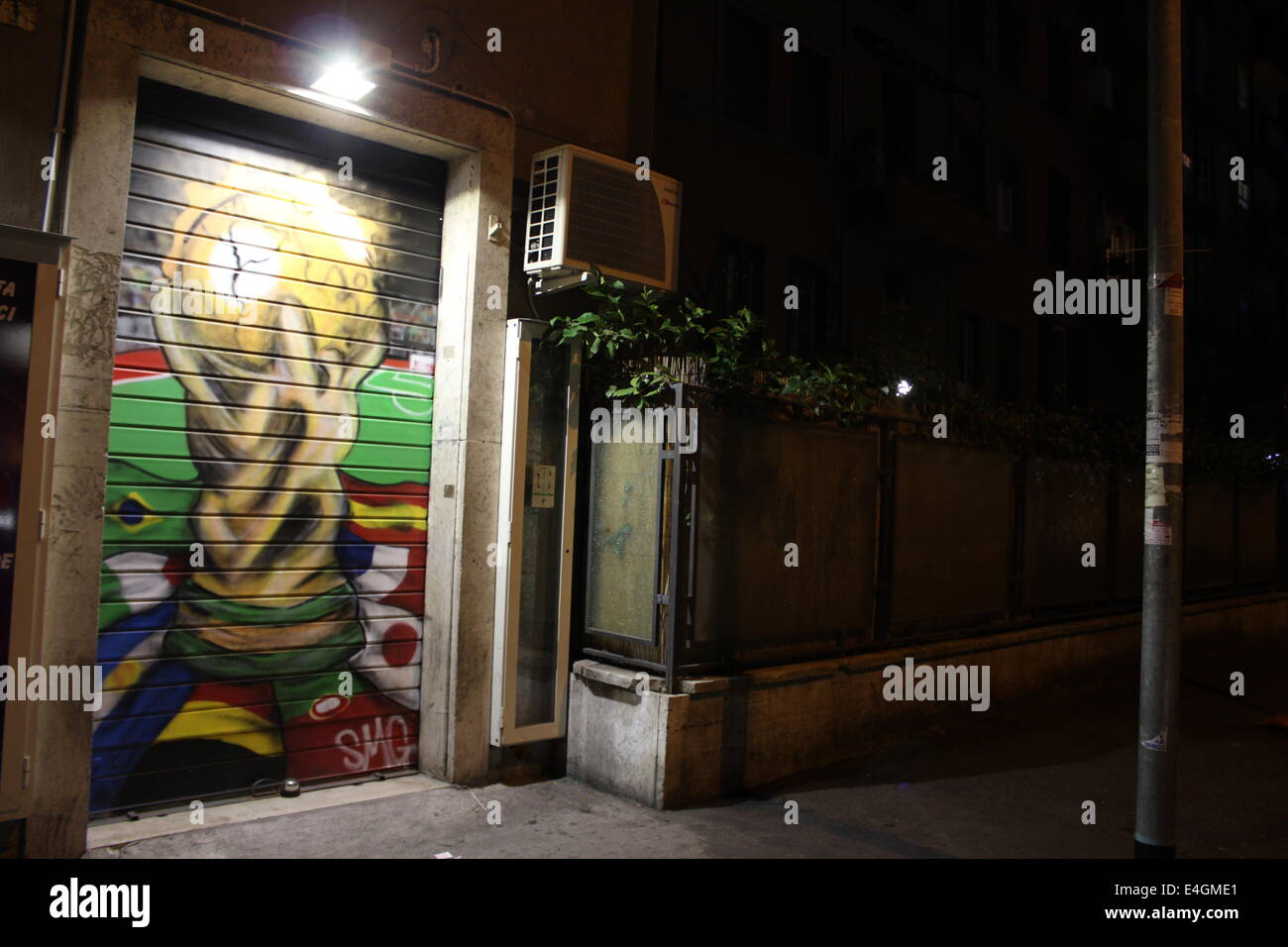 Rome, Italy 10th July 2014 Shop shutter adorned with World Cup trophy ...