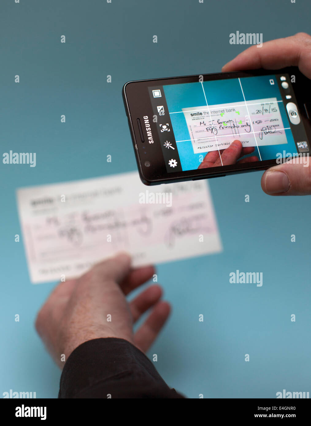 Paying in cheque hi-res stock photography and images - Alamy