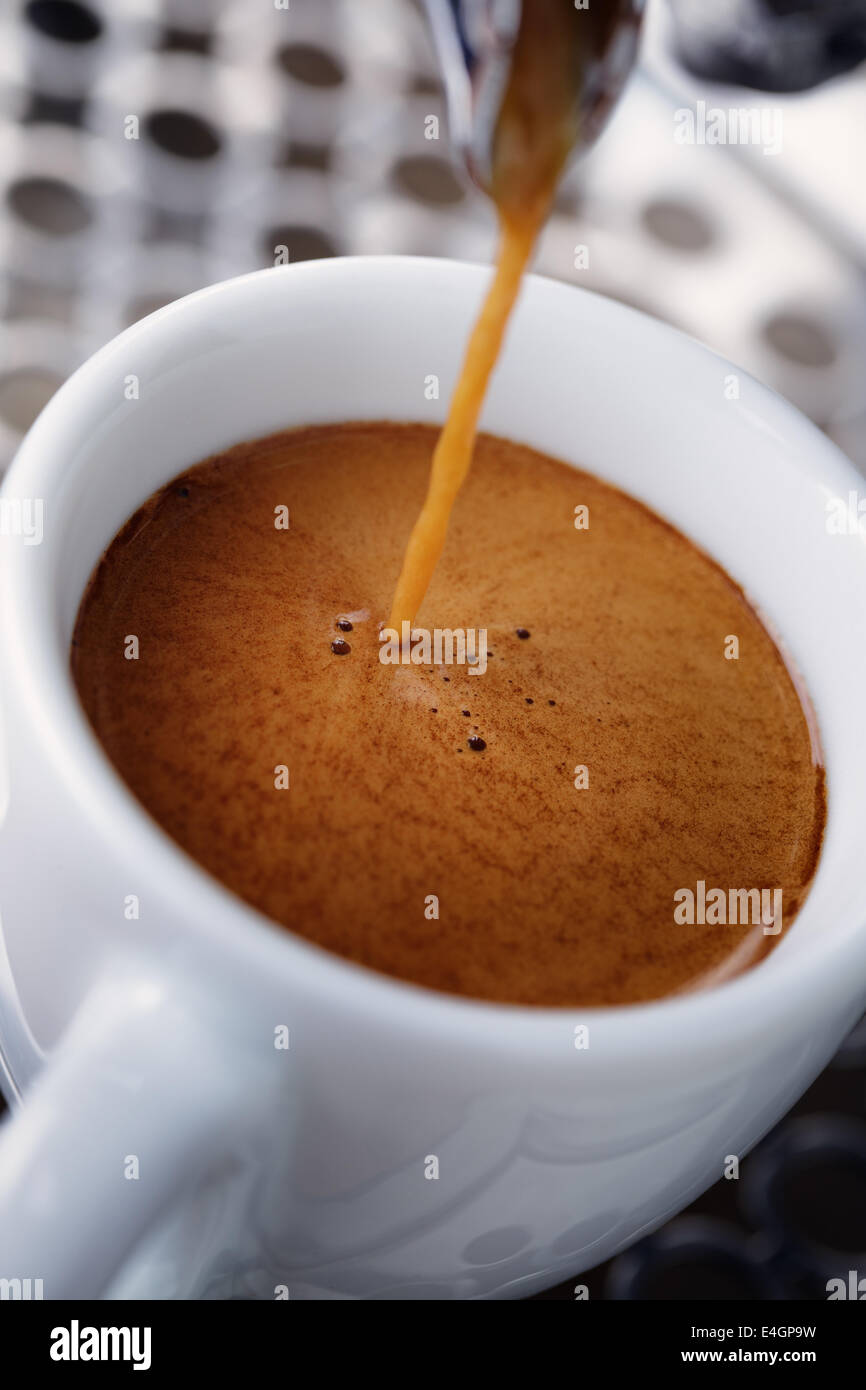 pouring simple espresso with coffee machine, close up Stock Photo - Alamy