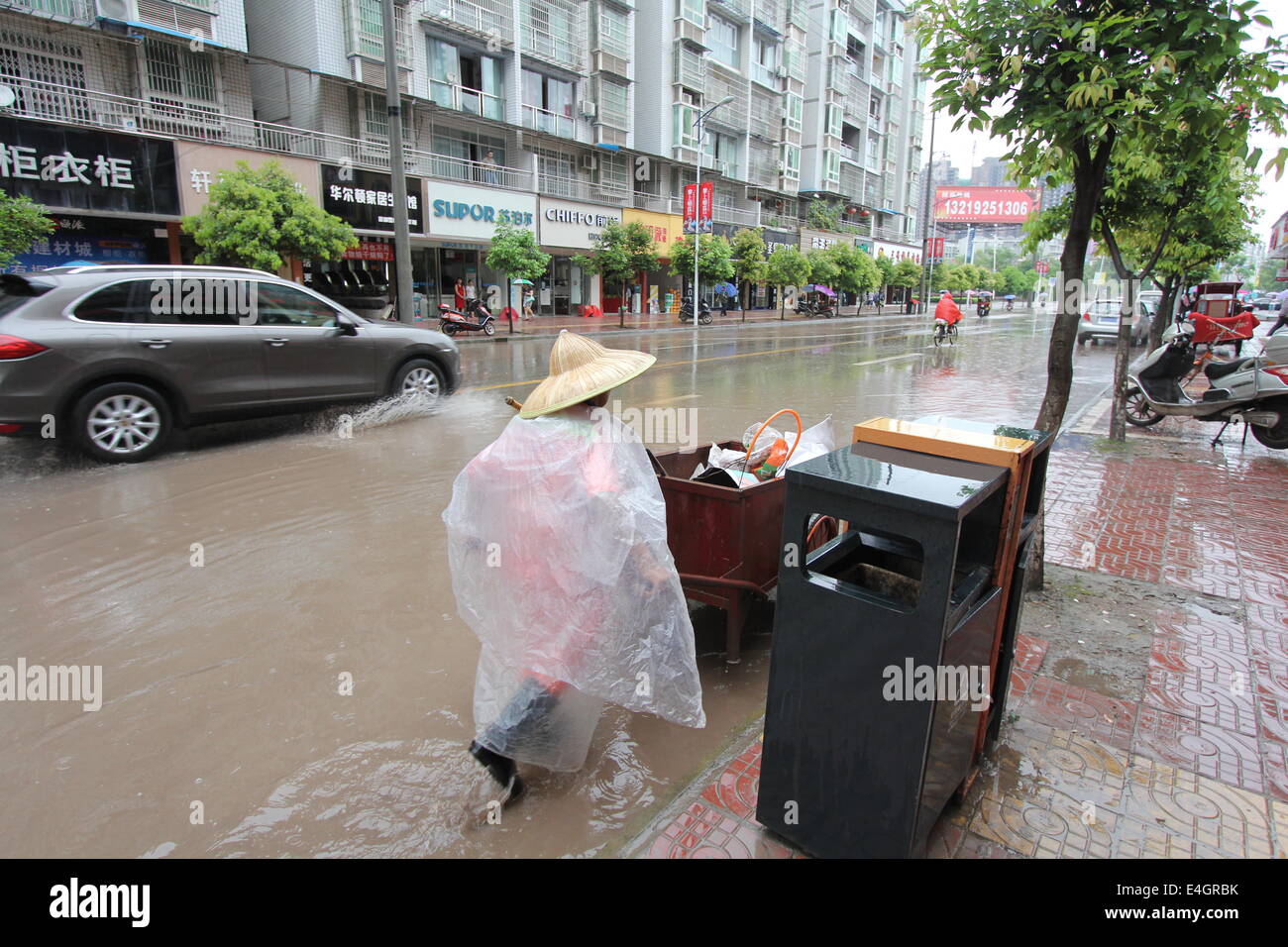Guang'an, China's Sichuan Province. 11th July, 2014. A sanitary worker ...