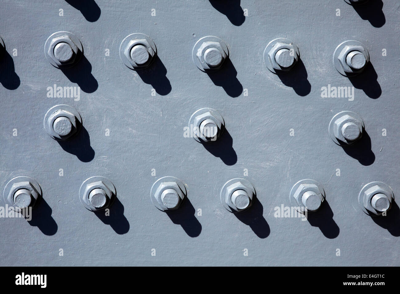 Old silver grey cast iron metal background with rivets of nuts and ...