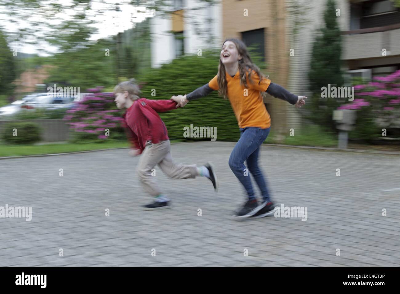 Boy girl running outside in hi-res stock photography and images - Alamy
