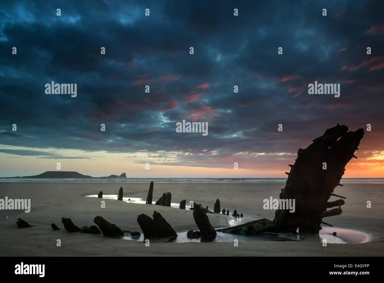 Dramatic sunset landscape over shipwreck on Rhosilli Bay beach Stock ...