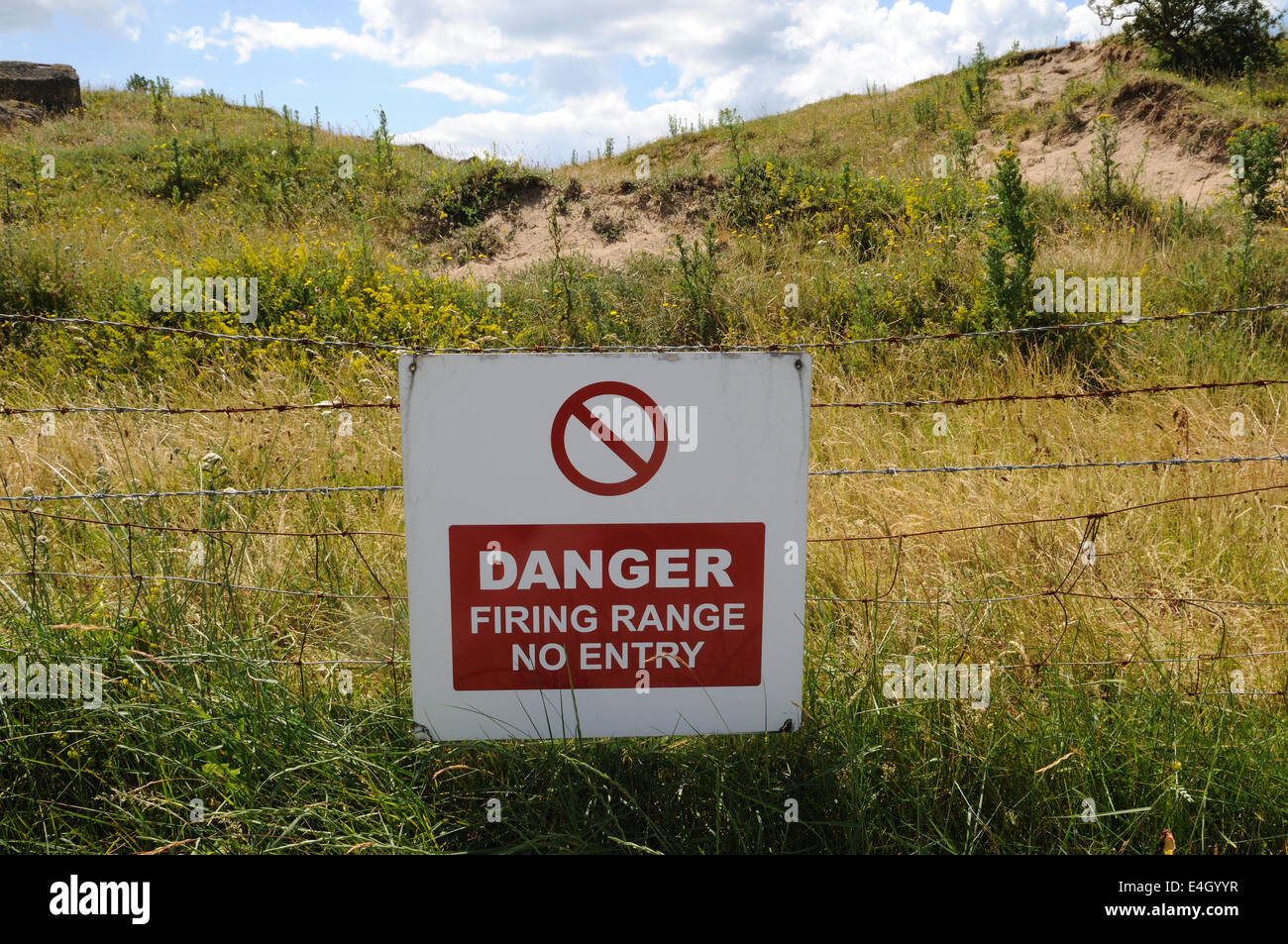 Danger warning sign on barbed wire on MOD land on walk to Ginst Point ...