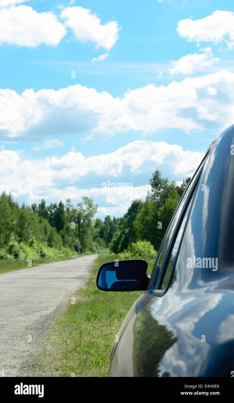 Lateral rear-view mirror of the car standing on a roadside of the ...