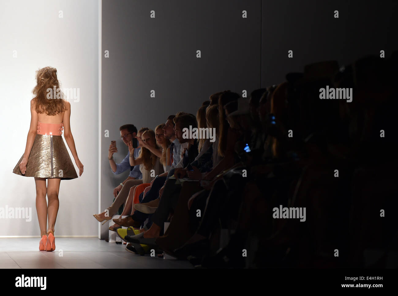 Berlin, Germany. 11th July, 2014. A model presents a fashion design of ...