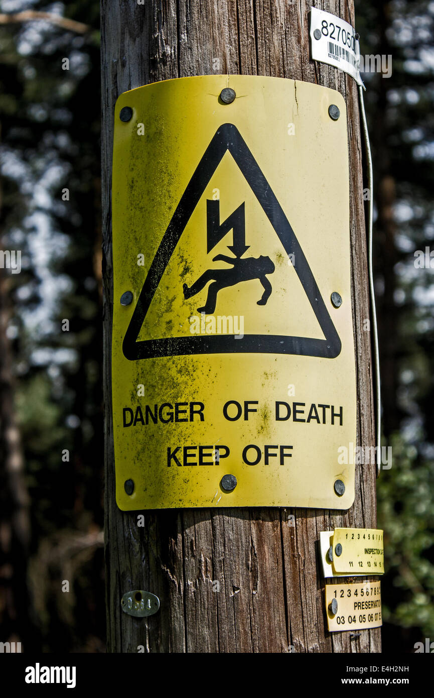 Warning Sign On A Power Pole Stock Photo - Alamy