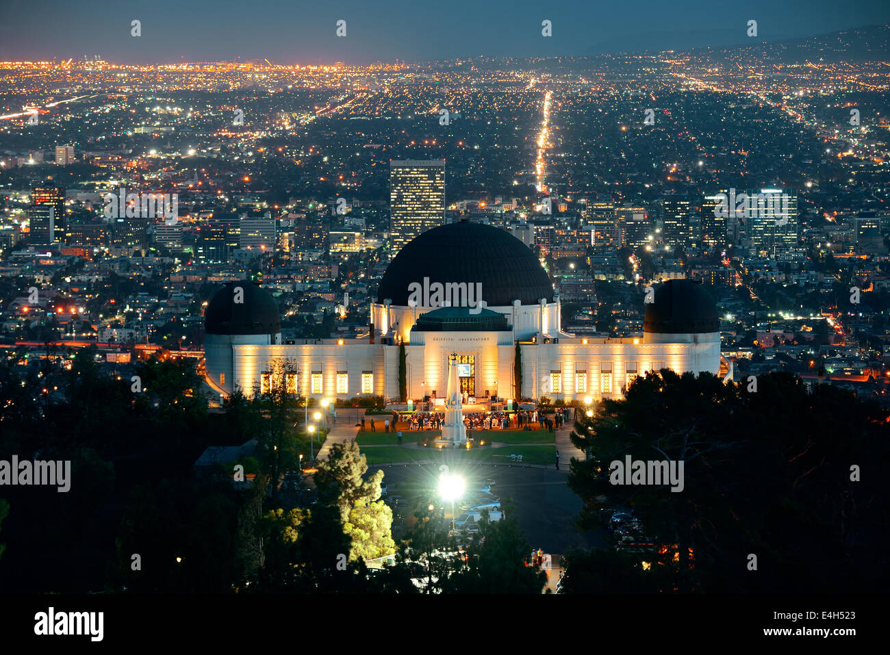 Los Angeles at night with urban buildings and Griffith Observatory ...