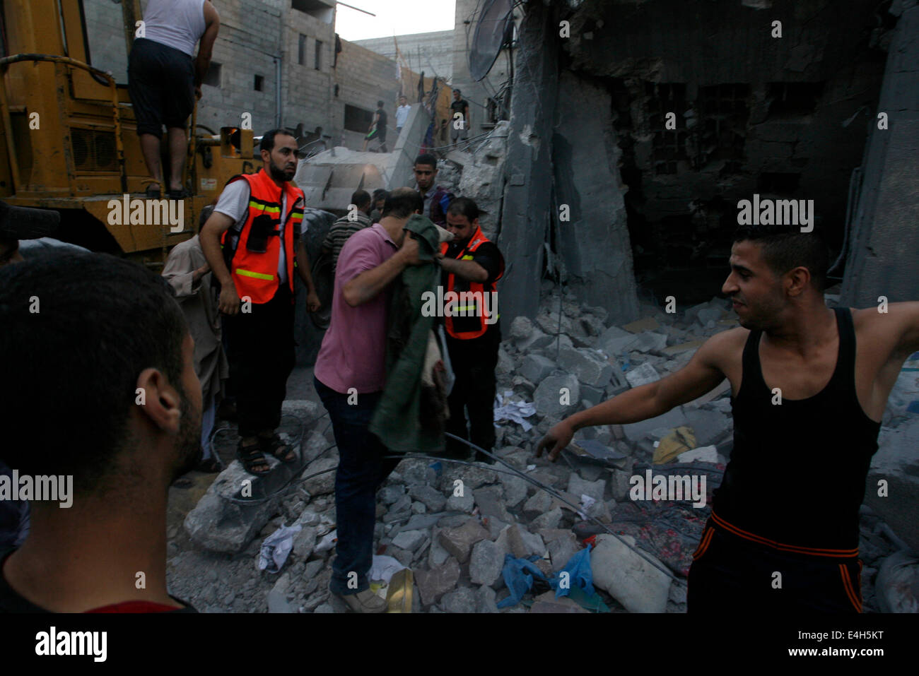 Palestinians clear the rubble of the house after it was targetted in an ...
