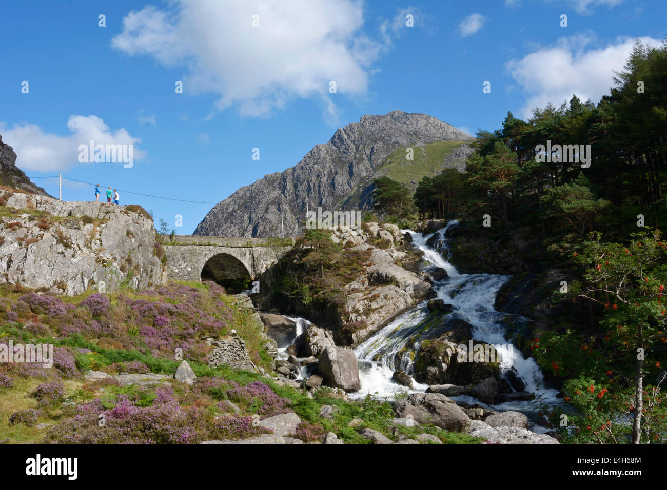 Tourists admire the scenery of Snowdonia by Ogwen Falls at Pont Pen y ...