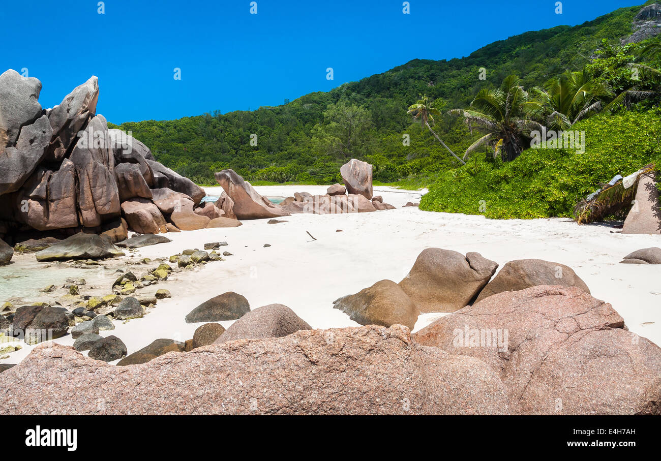 Granite Rocks Strewn On Tropical Beach Stock Photo - Alamy