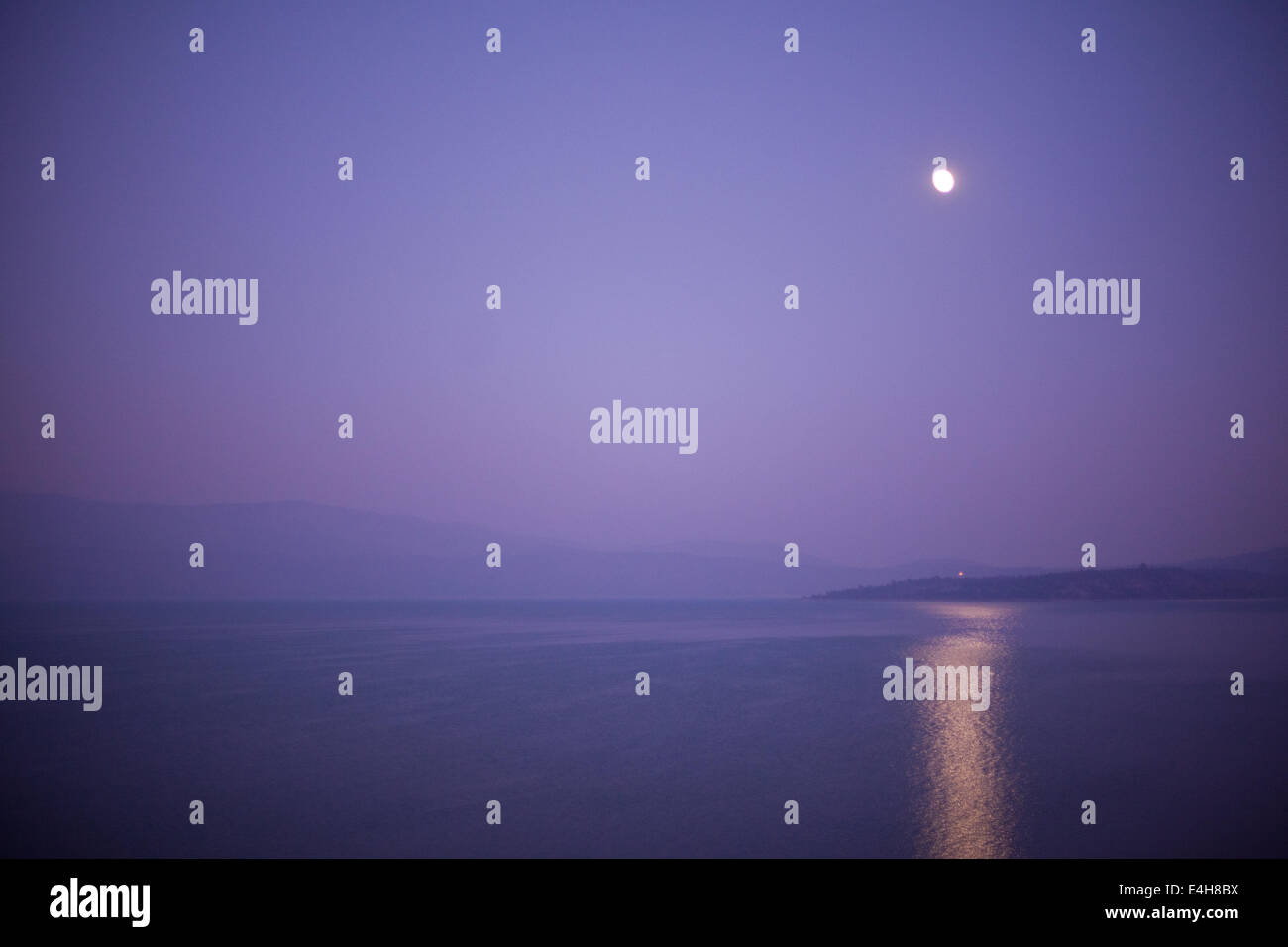 Moon over rainy lake Stock Photo - Alamy