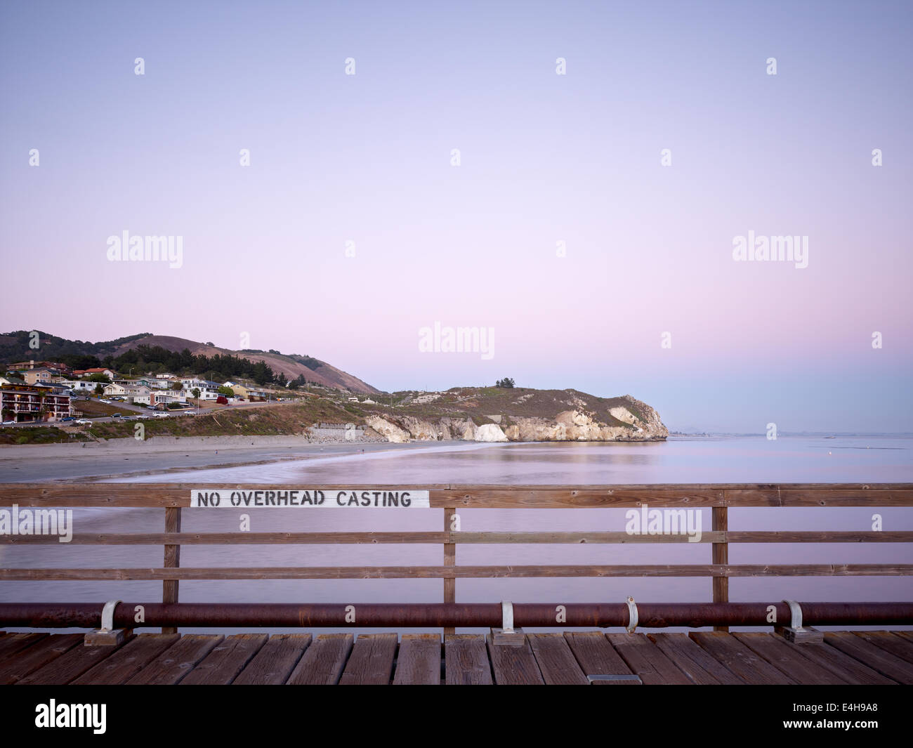 Pier overlooking coast sunset Stock Photo - Alamy