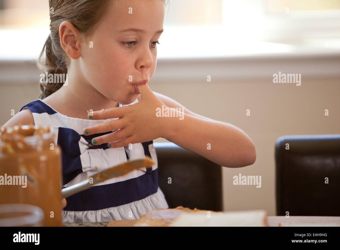 Girl eating peanut butter sandwich hi-res stock photography and images ...