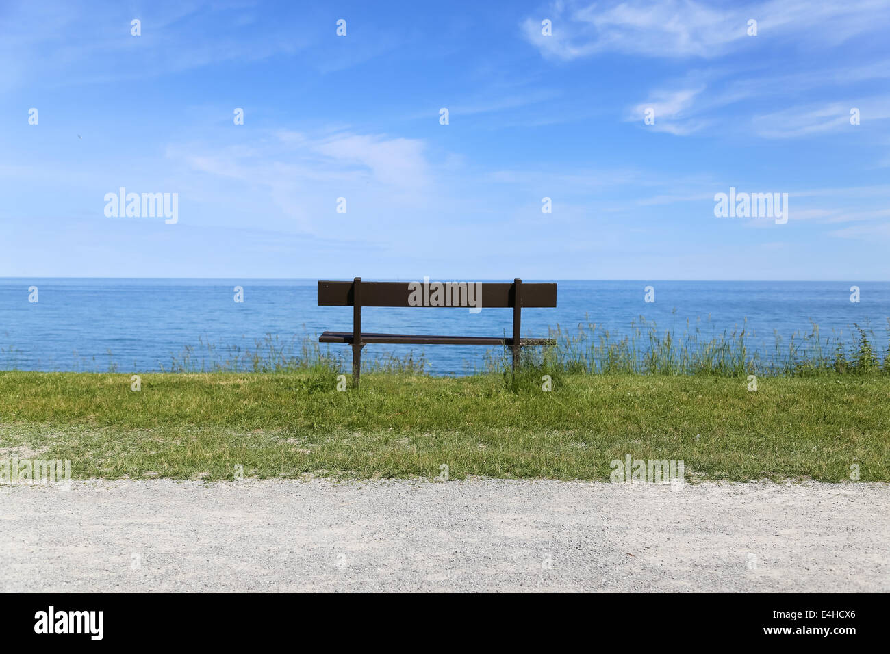 Empty Park Bench facing the ocean Stock Photo - Alamy