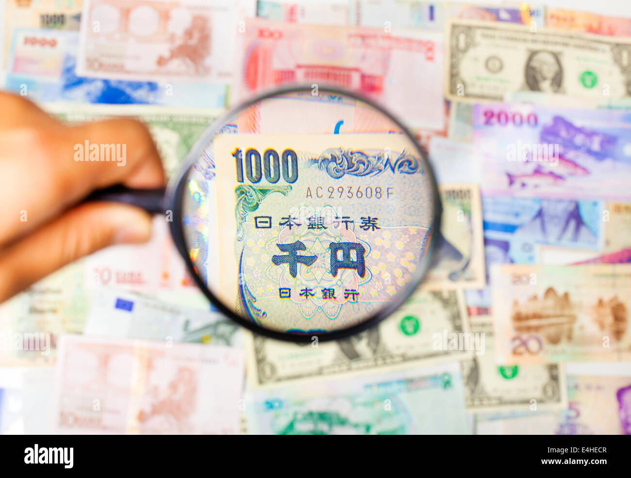 using a magnifier to search the method of Asian Market Stock Photo - Alamy