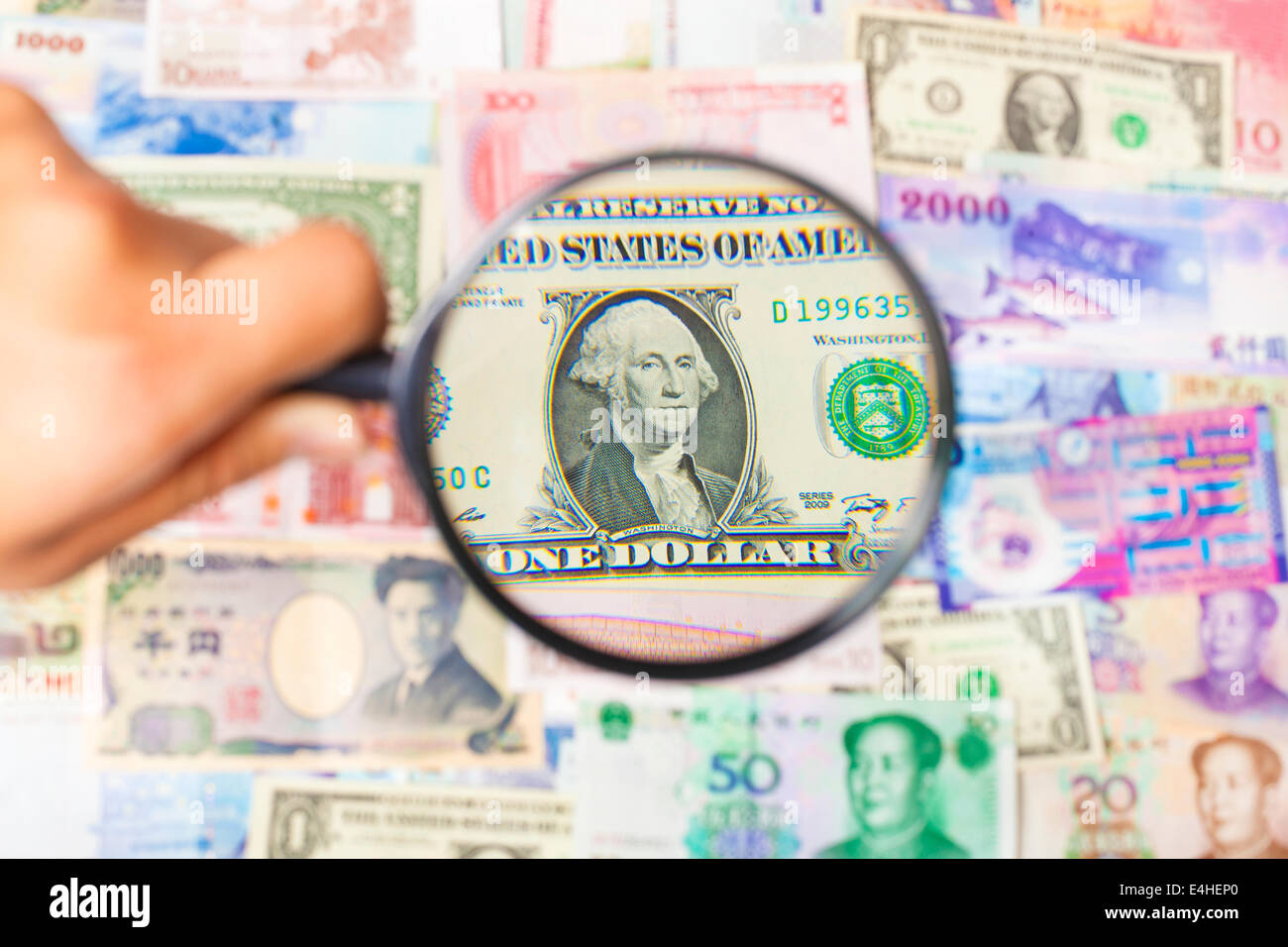 using a magnifier to search the method of making money Stock Photo - Alamy
