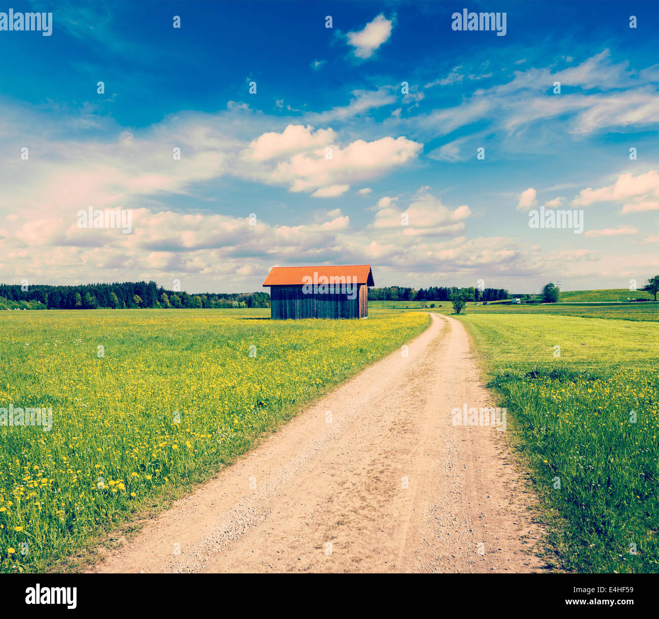 Vintage retro effect filtered hipster style image of rural road in ...