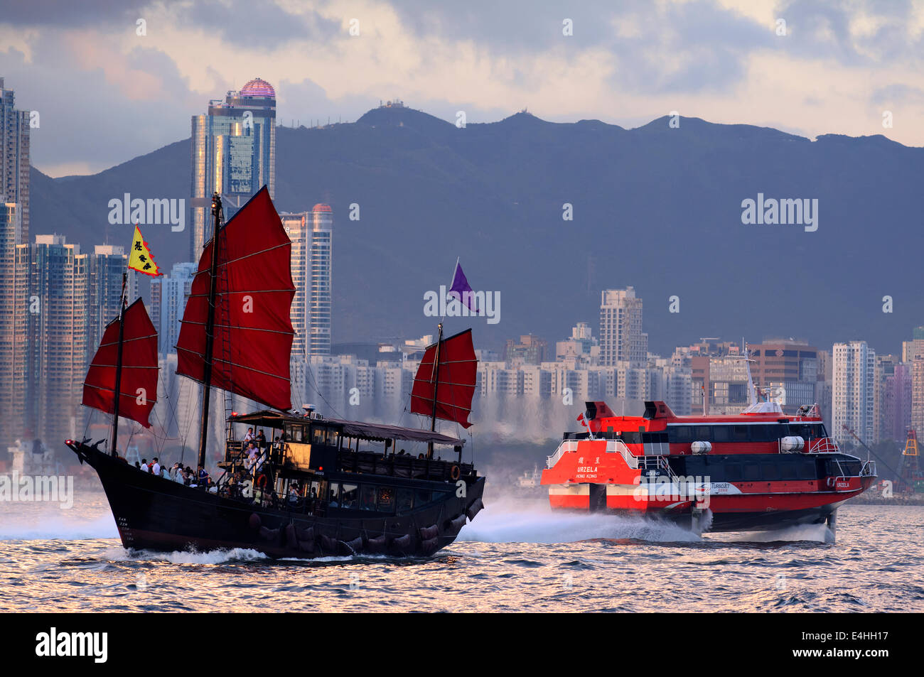 Traditional Chinese tourist junk and the red Macau turbo jet ferry ...