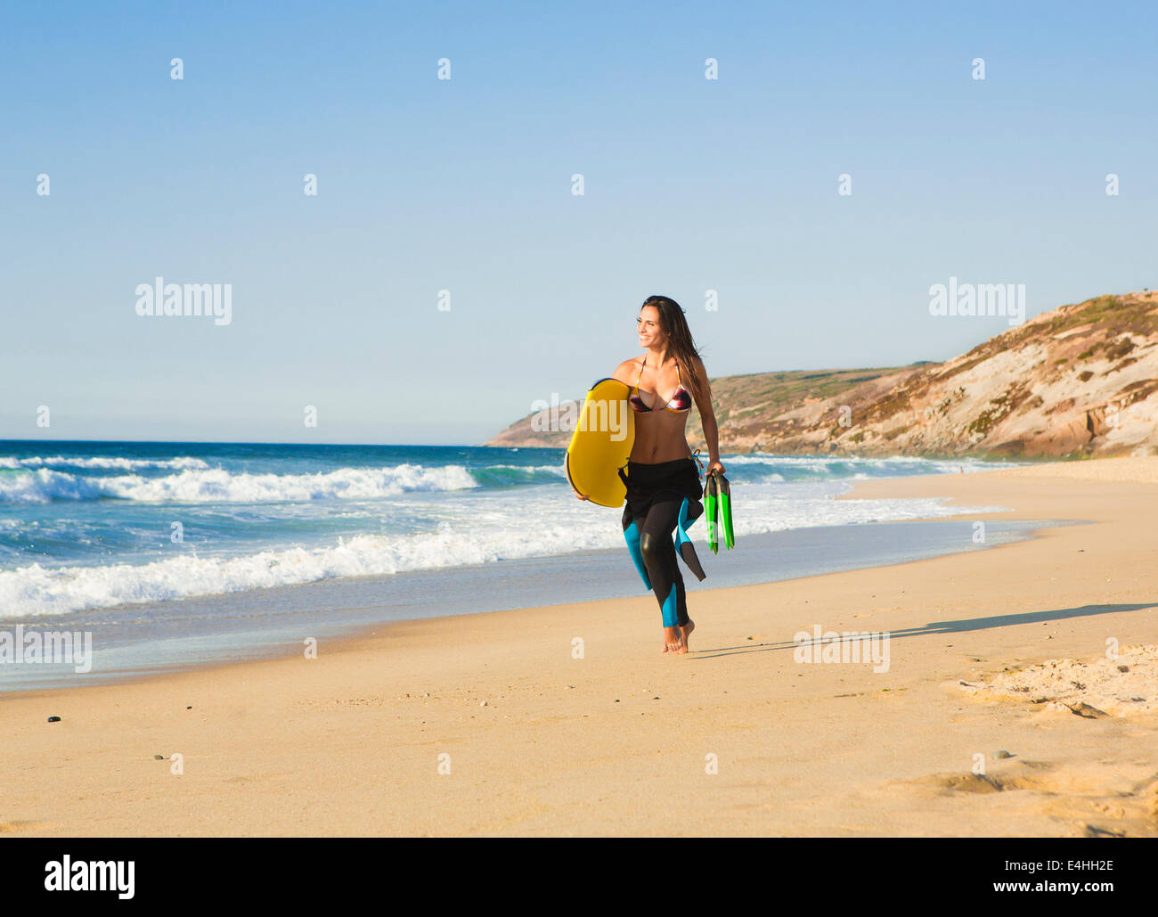 A beautiful girl running at the beach with her bodyboard Stock Photo ...