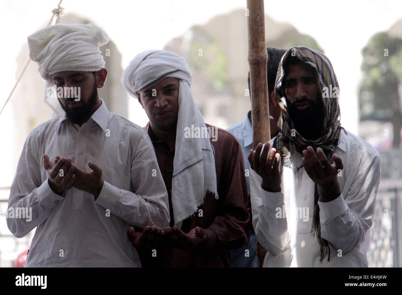 Lahore, Pakistan. 12th July, 2014. Muslims pray at Data Darbar shrine ...