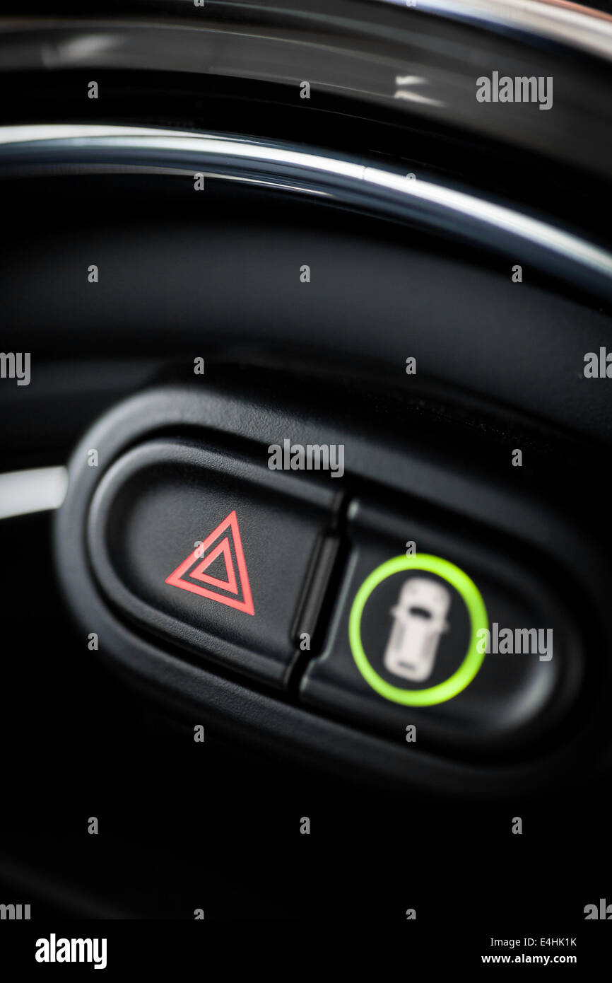 Detail of a warning button in a car Stock Photo - Alamy