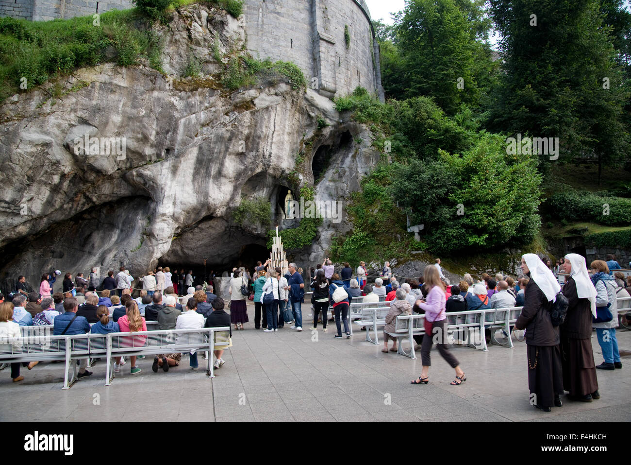people are praying in Lourdes Stock Photo - Alamy