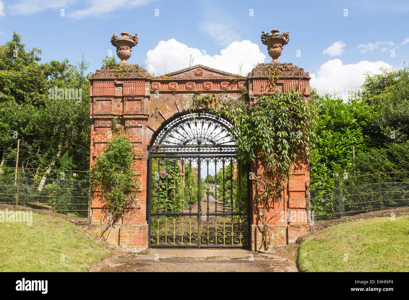 Brickwork arch and black wrought ironwork gate to Walled Garden of ...