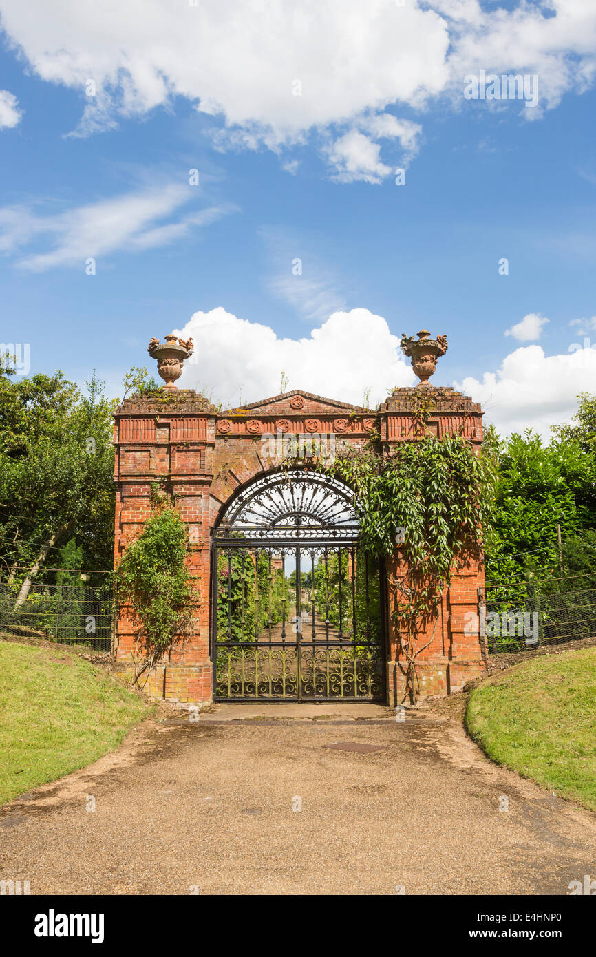Brickwork arch and black wrought ironwork gate to Walled Garden of ...