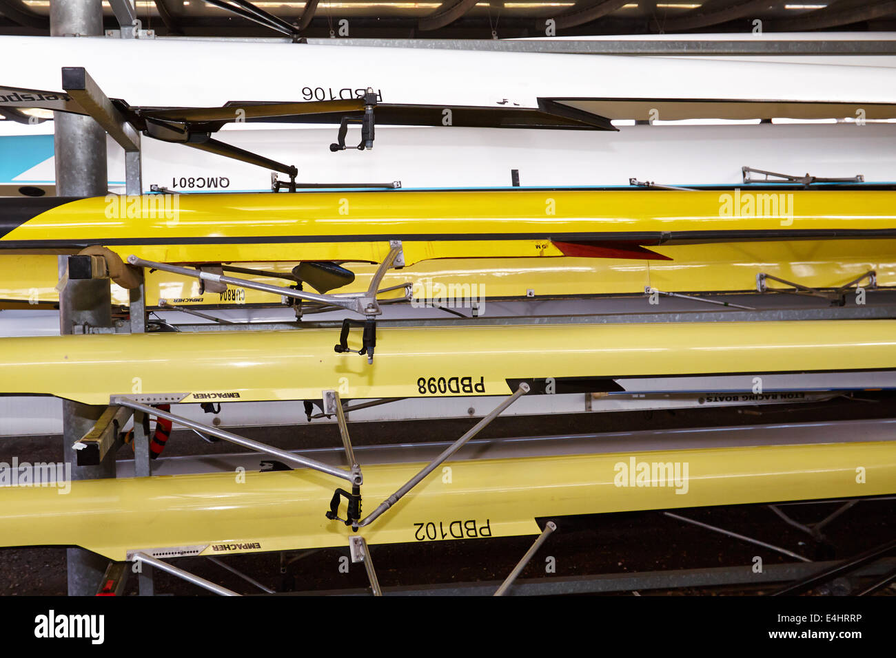 Upturned fibre glass rowing boats being stored in a boat house Stock ...