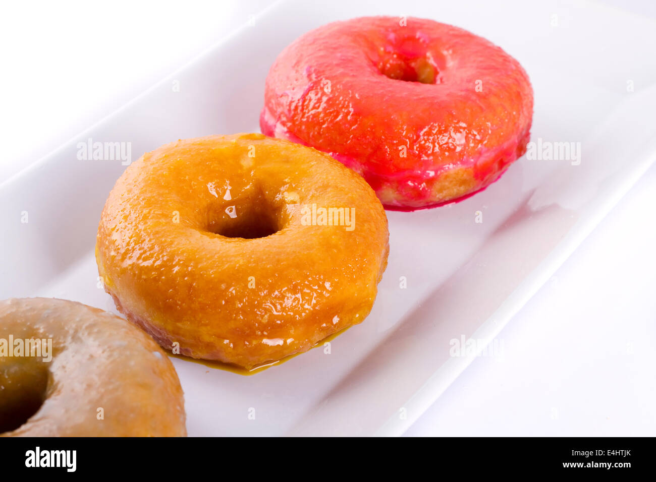 Colorful donut on a plate Stock Photo - Alamy