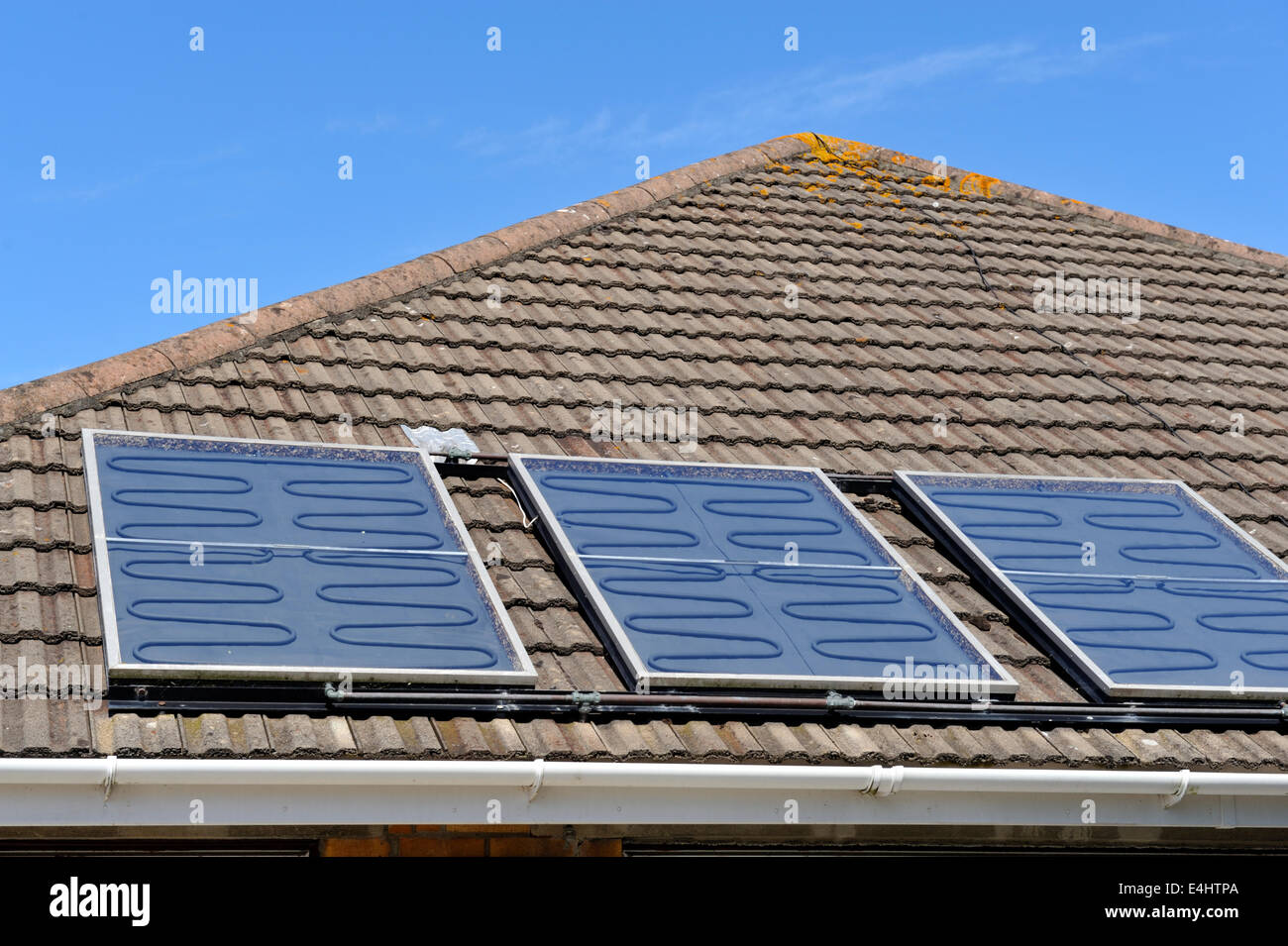 Fat plate solar thermal panels on roof of house for providing hot water ...
