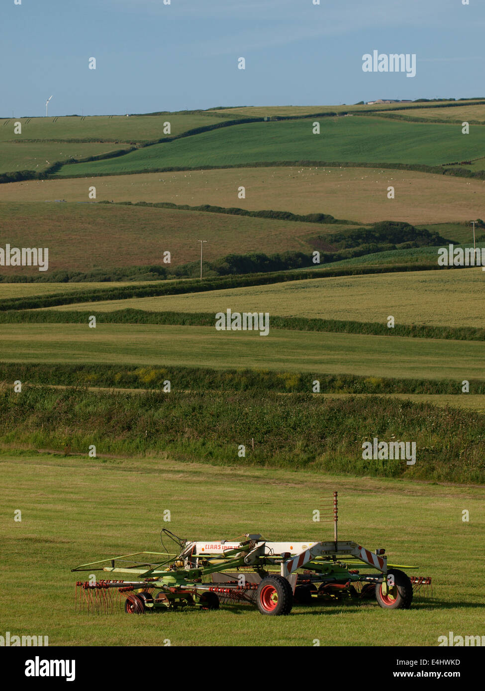 Claas Liner Swather rotor rake and fields, Cornwall, UK Stock Photo - Alamy