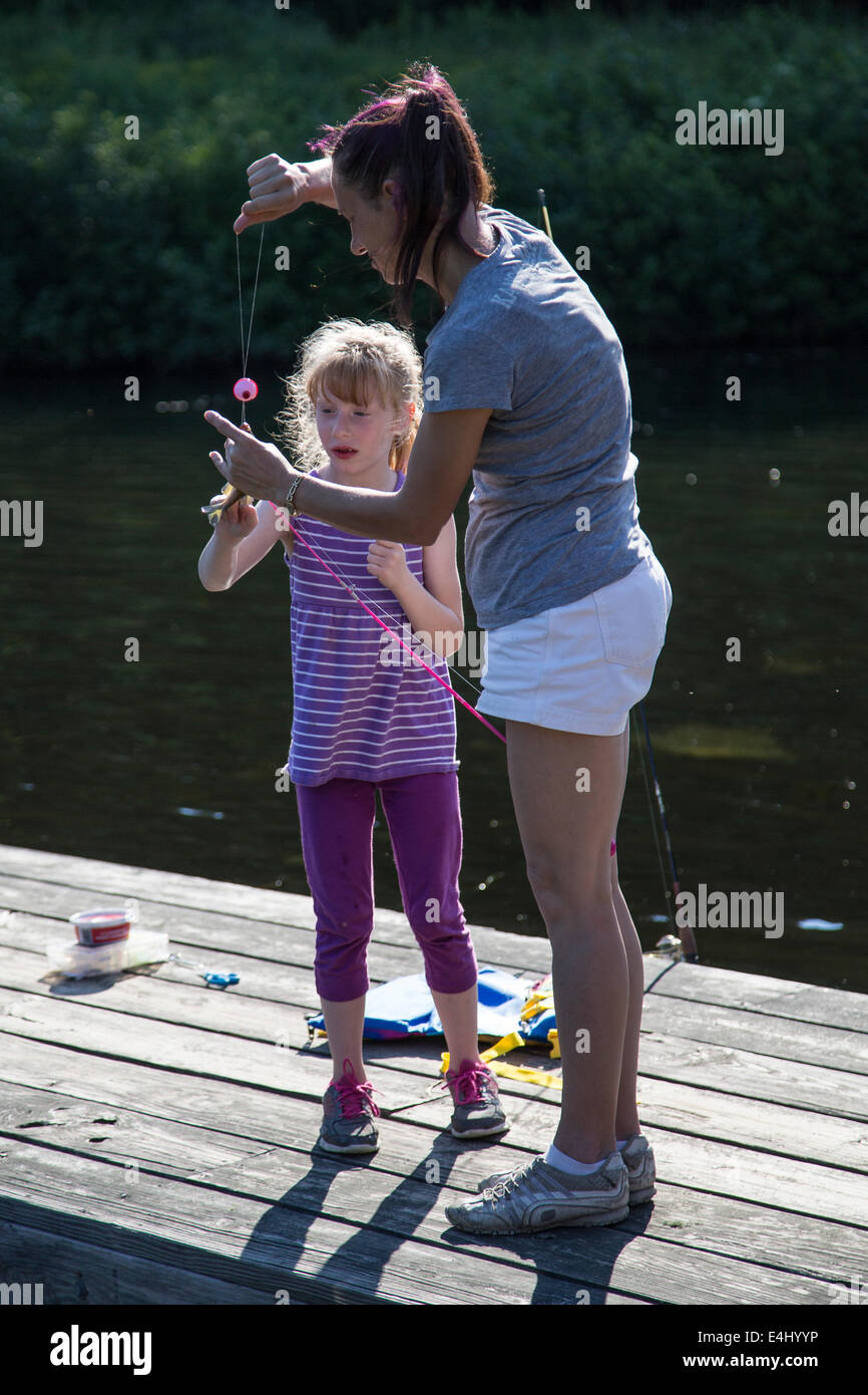 Mother with daughter catches a fish Stock Photo - Alamy