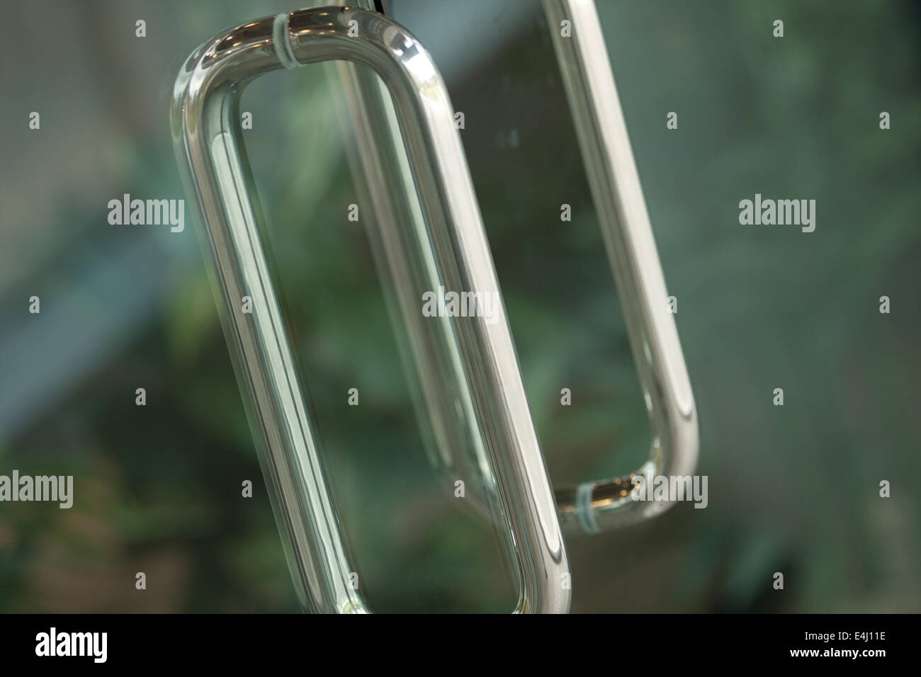 Handles on glass doors Stock Photo - Alamy