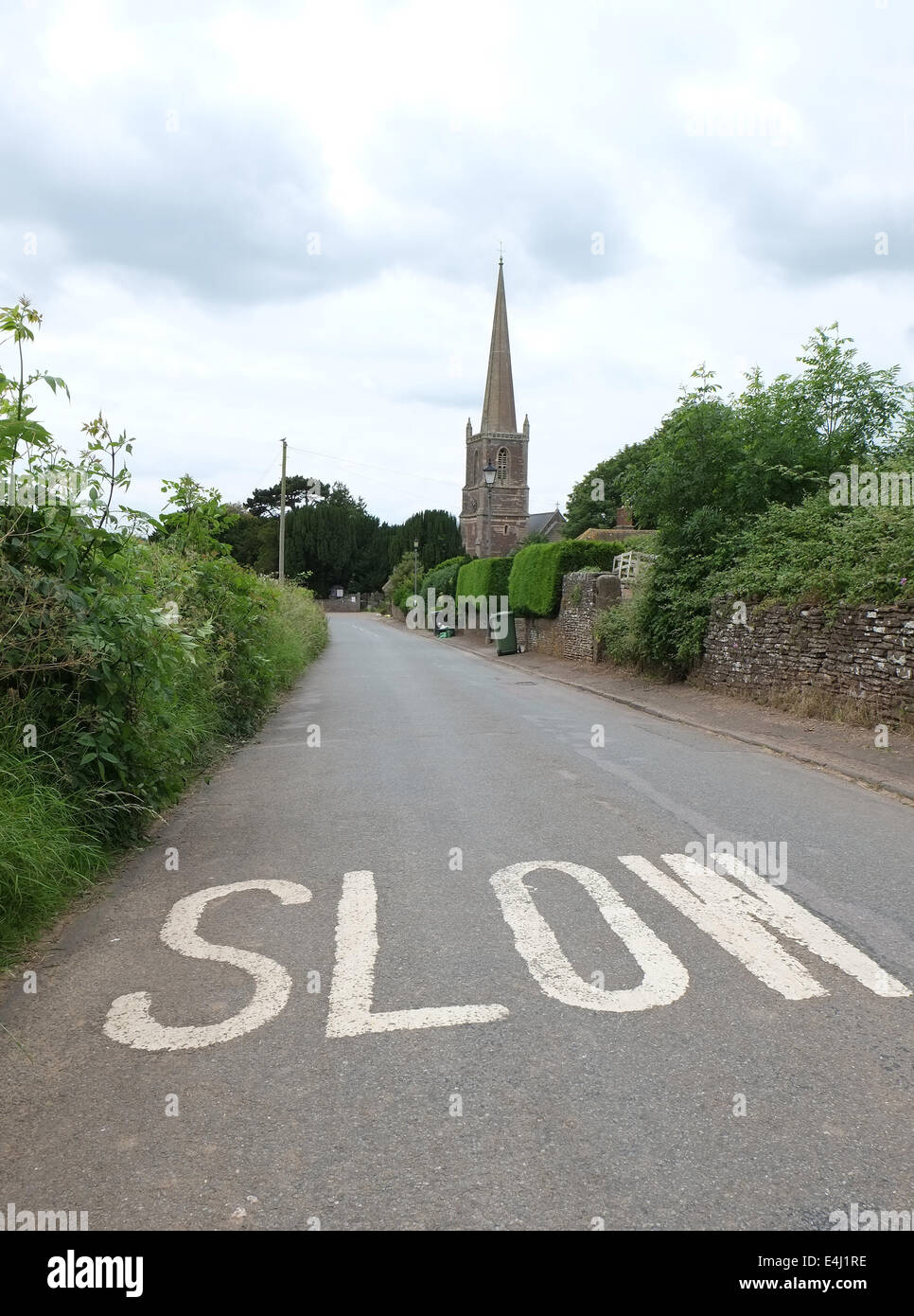 slow sign painted on the road on the approaches to Winterbourne Church ...