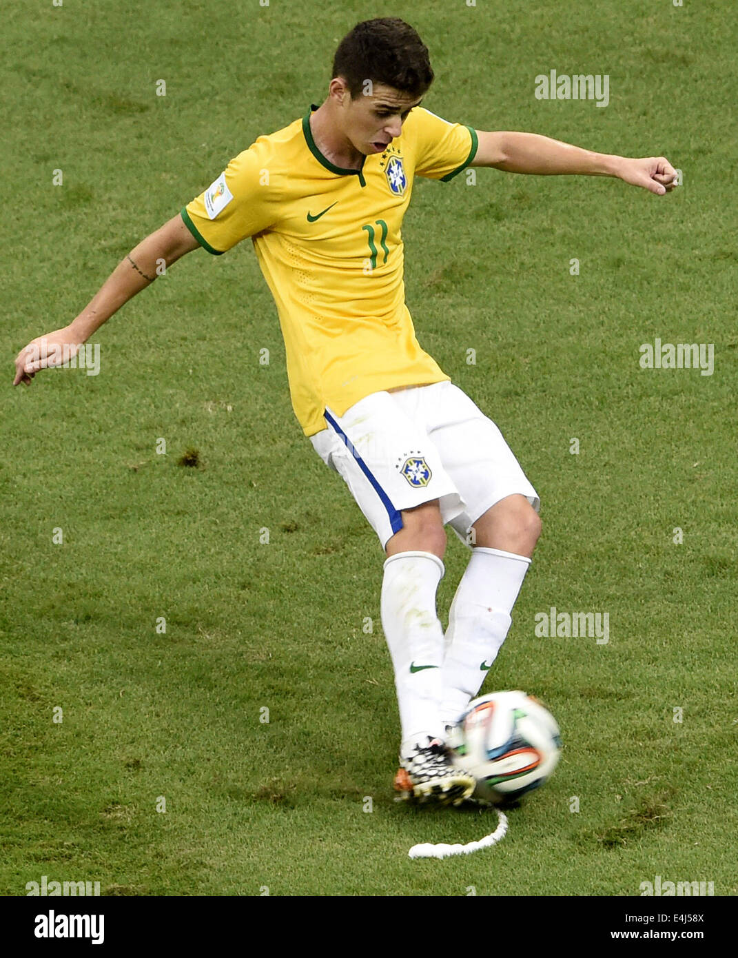 Brasilia, Brazil. 12th July, 2014. Brazil's Oscar makes a free kick ...